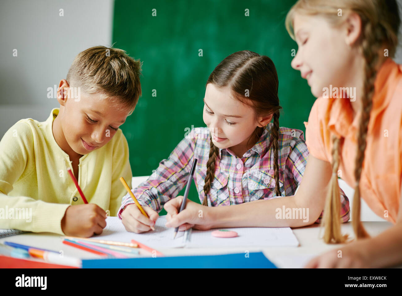 Group of cute schoolmates drawing at lesson Stock Photo - Alamy