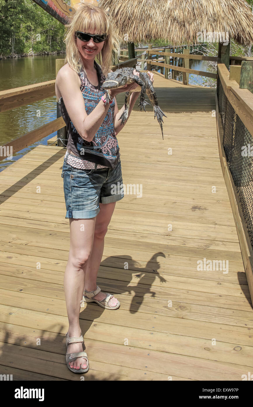 Woman with alligator Stock Photo - Alamy