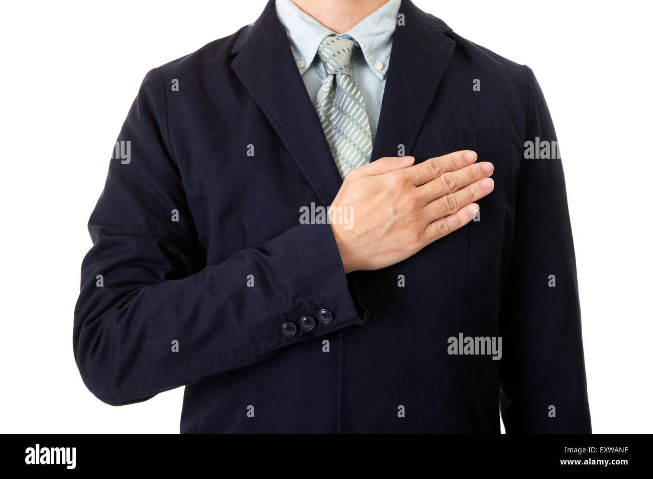 Man making oath with hand on chest Stock Photo - Alamy