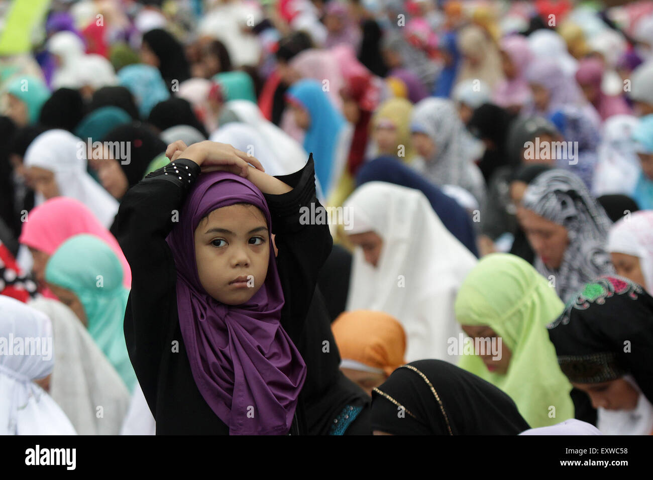 Quezon City, Philippines. 17th July, 2015. A girl looks on when Muslim ...