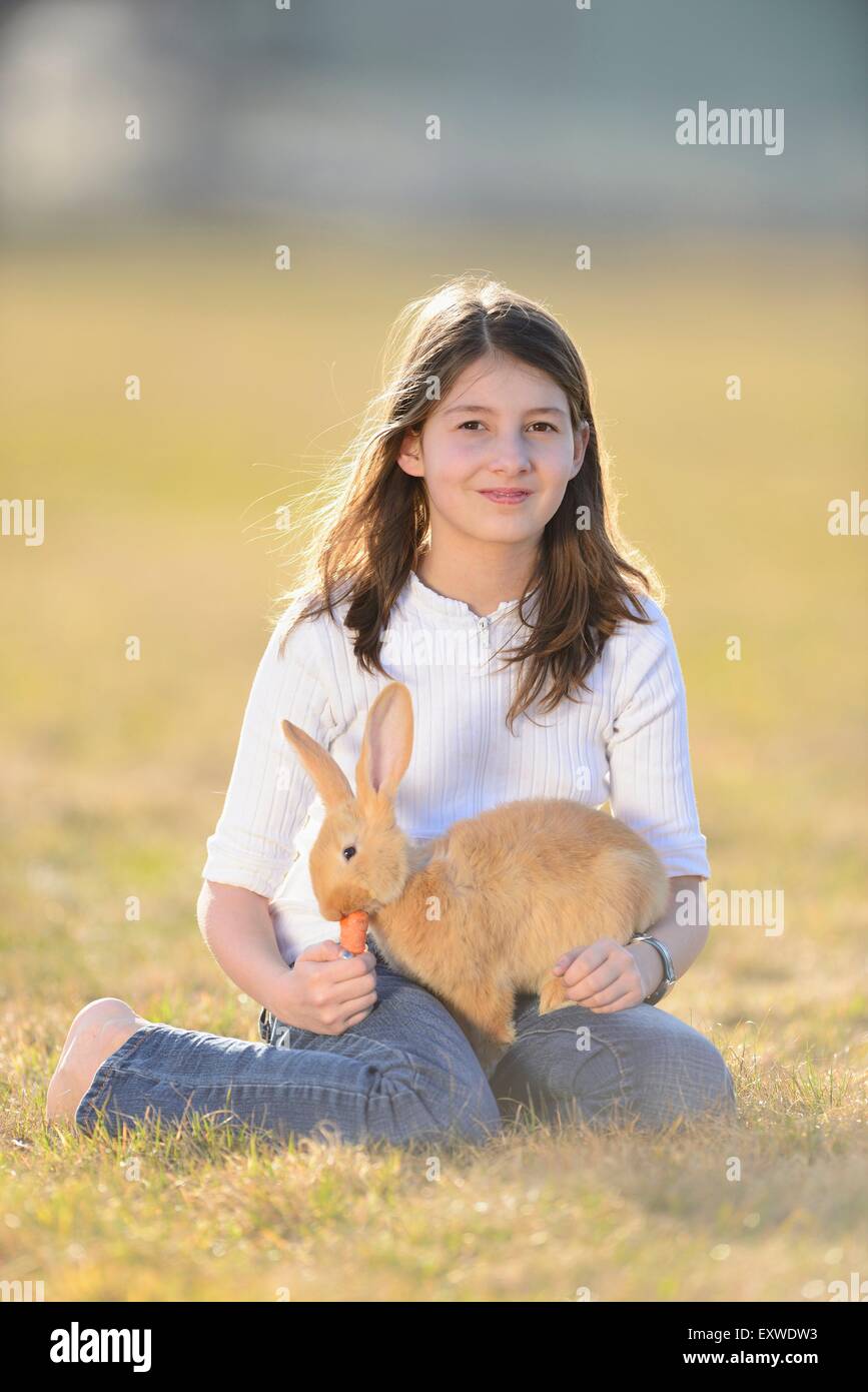 Teenage girl with her rabbit on a meadow, Upper Palatinate, Bavaria ...