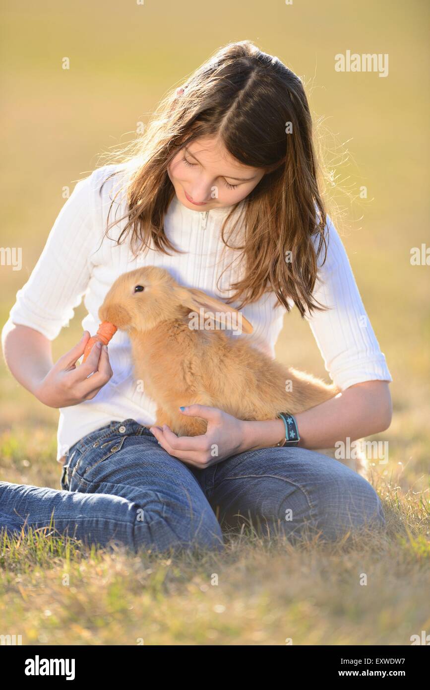 Teenage girl with her rabbit on a meadow, Upper Palatinate, Bavaria ...