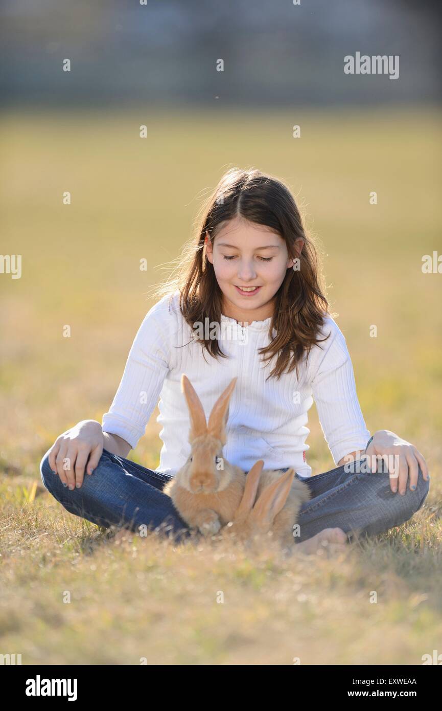 Teenage girl with her rabbit on a meadow, Upper Palatinate, Bavaria ...