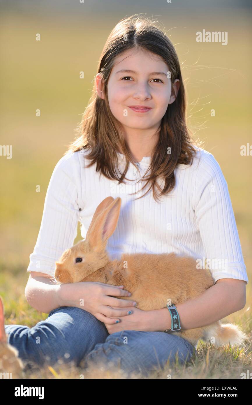 Teenage girl with her rabbit on a meadow, Upper Palatinate, Bavaria ...
