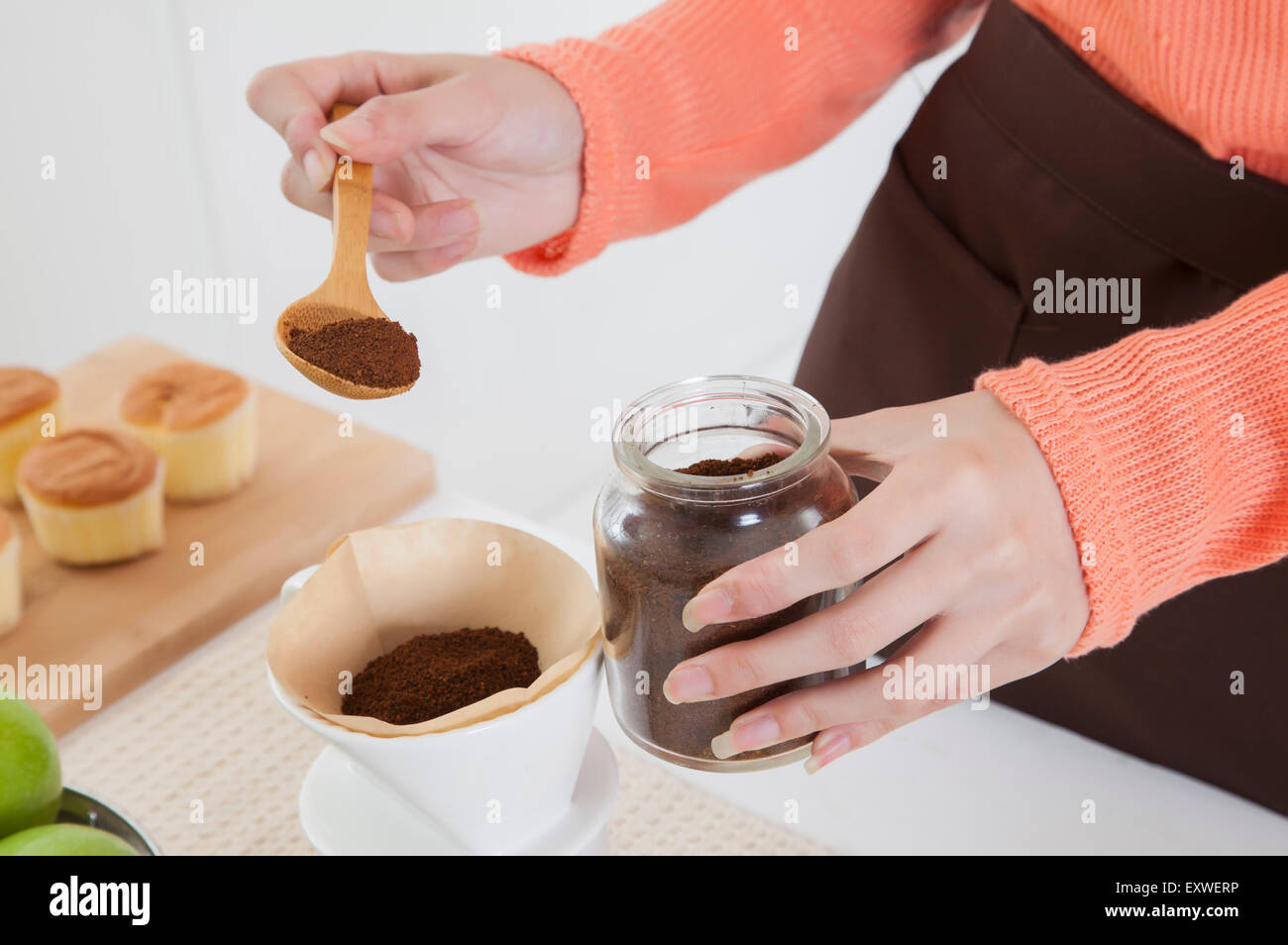 Young woman making coffee in the kitchen Stock Photo - Alamy
