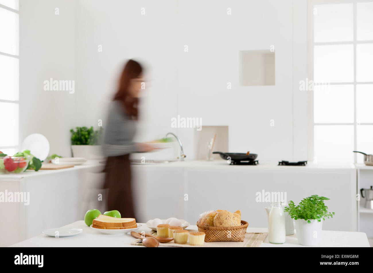 Young woman making breakfast in the kitchen Stock Photo - Alamy