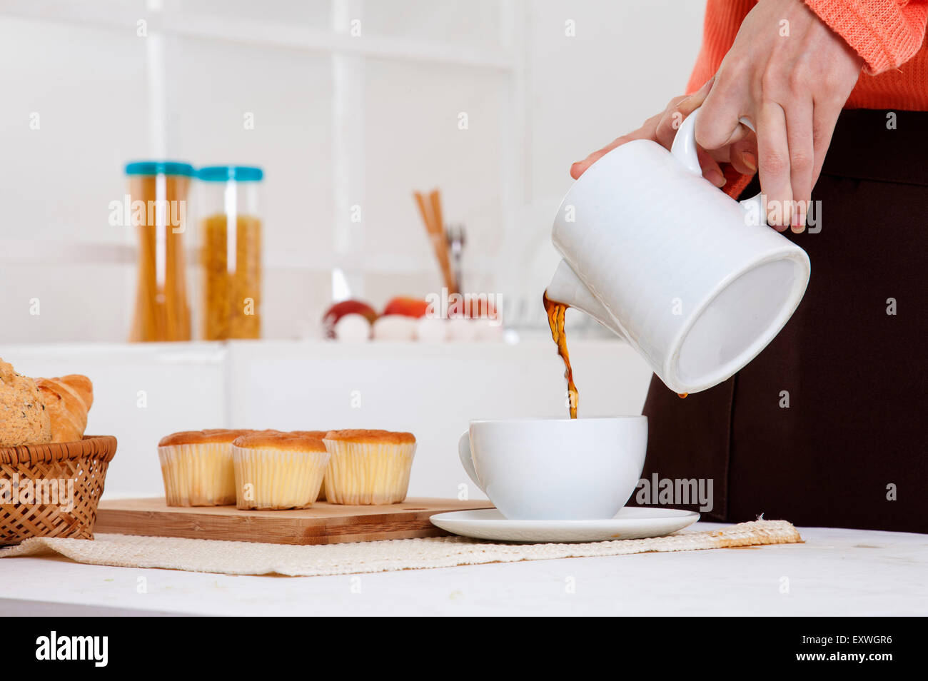 Young woman making coffee for breakfast Stock Photo - Alamy