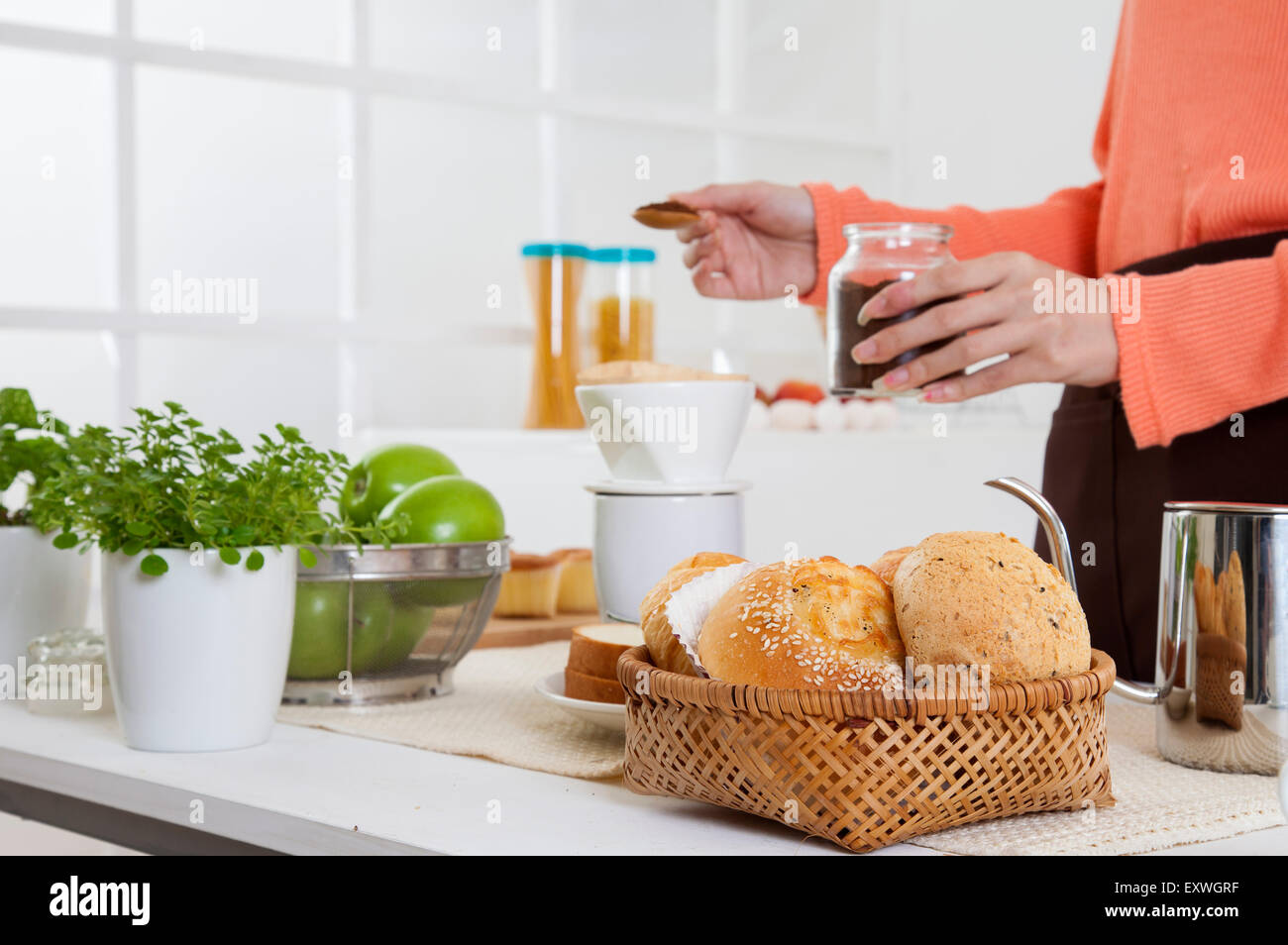 Young woman making coffee for breakfast in the kitchen Stock Photo - Alamy