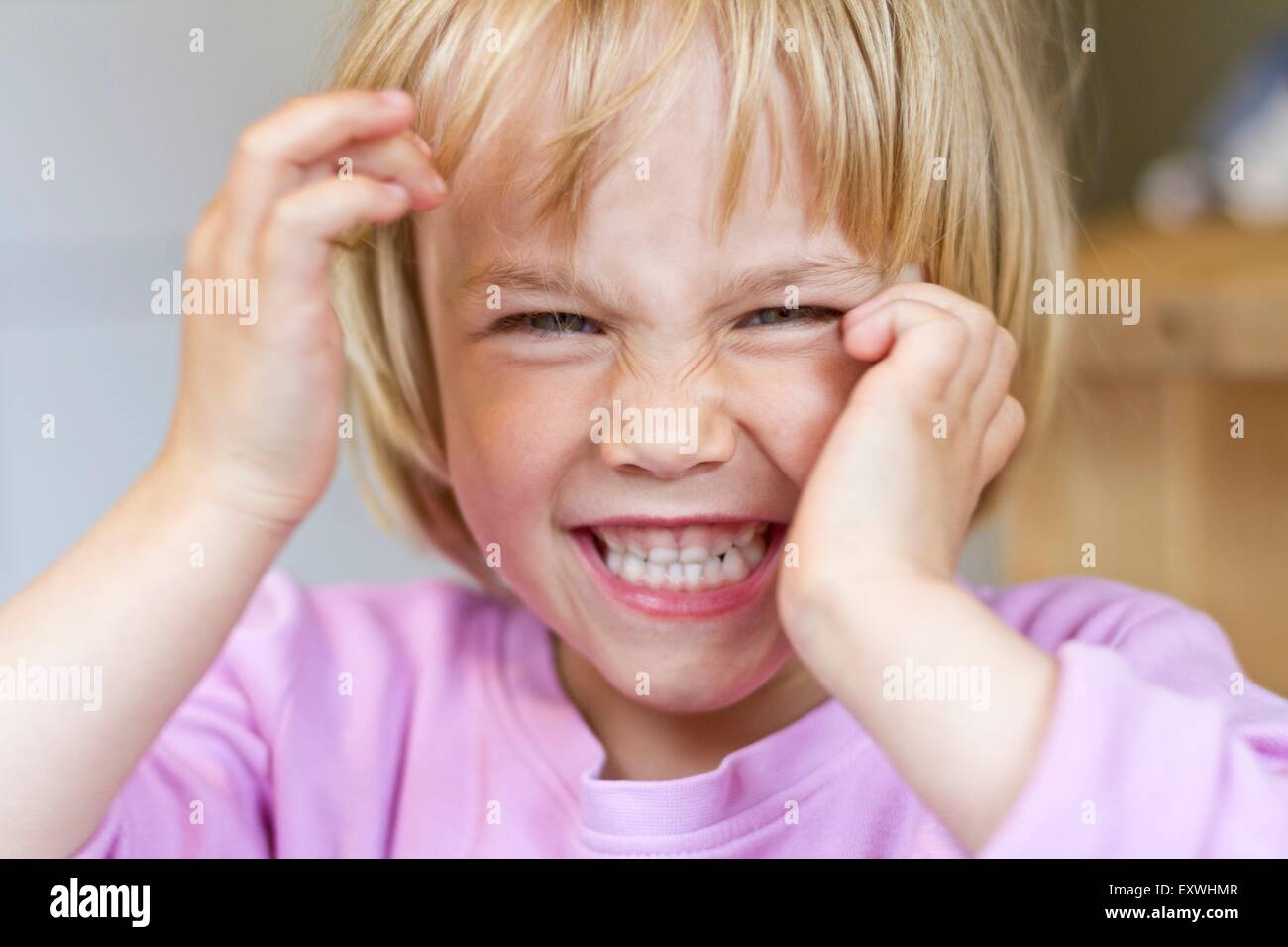 Girl pulling faces Stock Photo - Alamy
