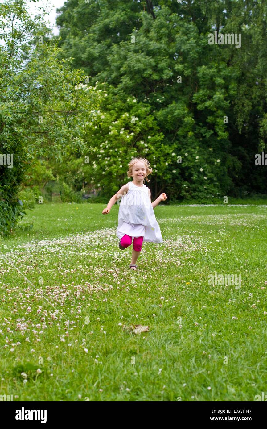 Girl running over meadow Stock Photo - Alamy