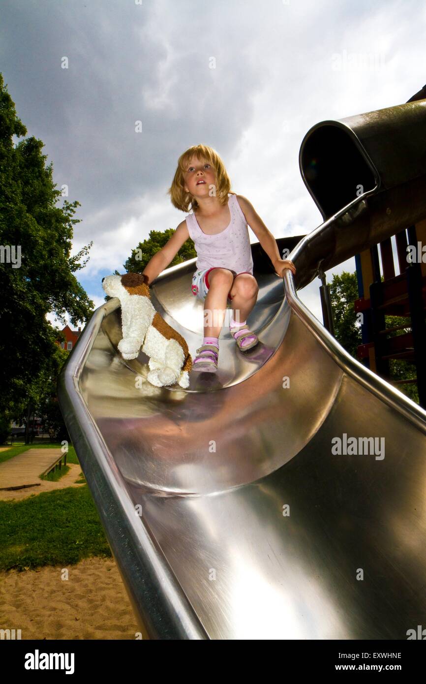 Girl on a slide Stock Photo - Alamy