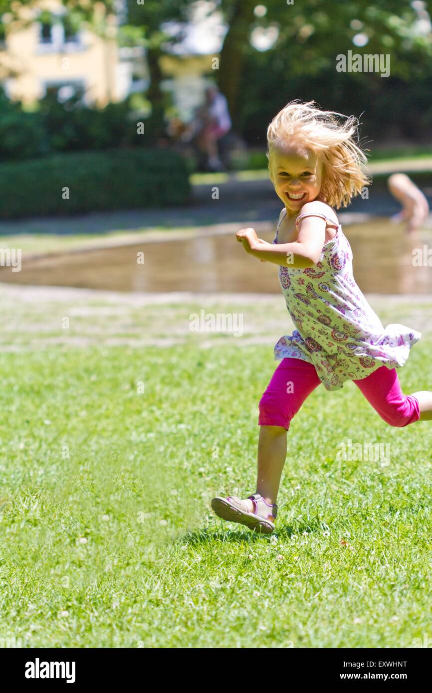 Girl running over meadow Stock Photo - Alamy