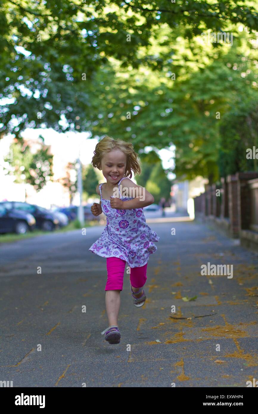 Girl running on walkway Stock Photo - Alamy
