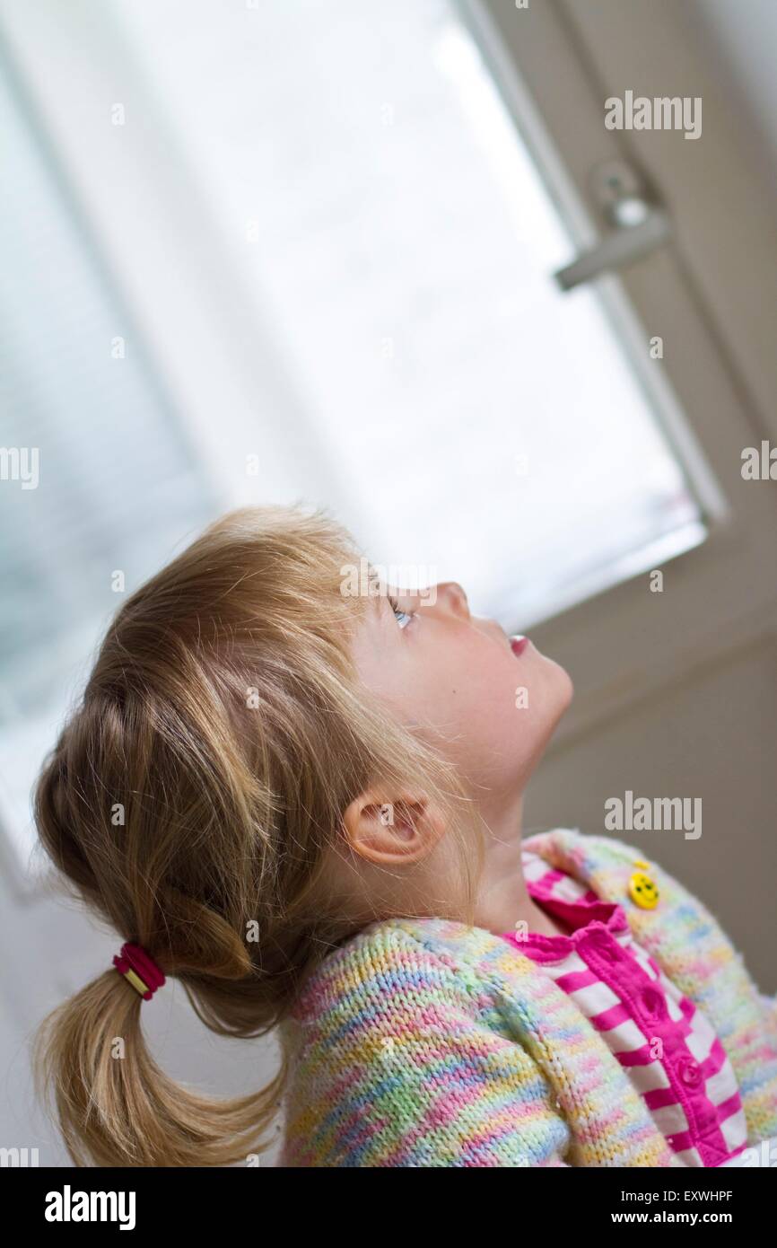 Blond girl looking up Stock Photo - Alamy