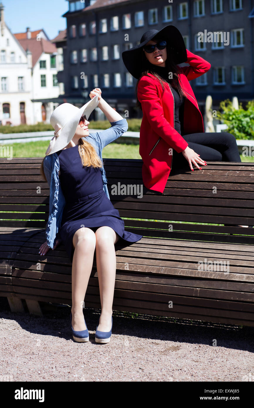 Woman in white hat looks at friend Stock Photo - Alamy