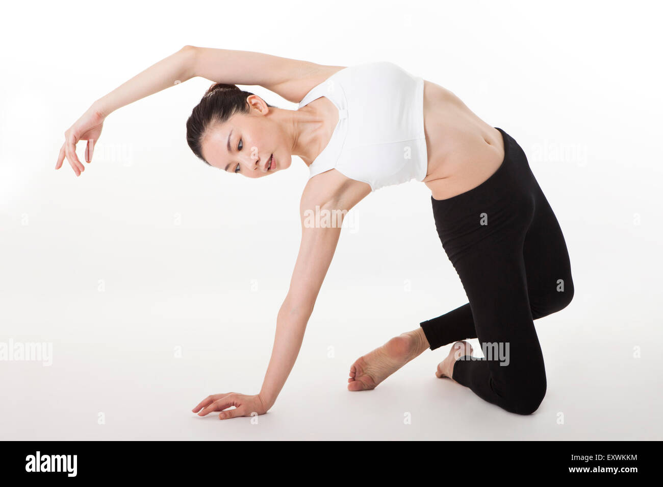 Woman practicing yoga and stretching Stock Photo - Alamy