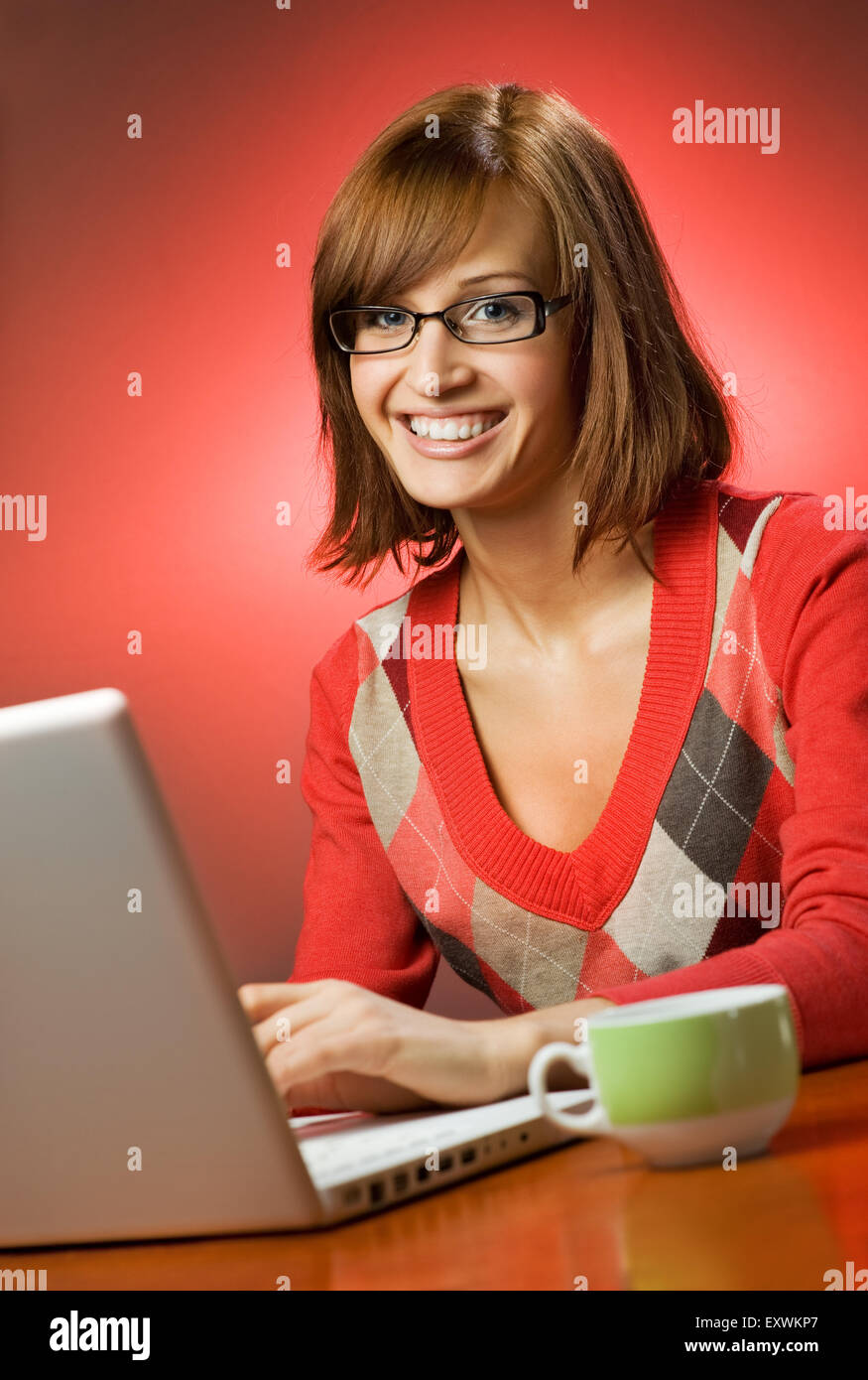 Beautiful smiling woman working on her laptop Stock Photo - Alamy