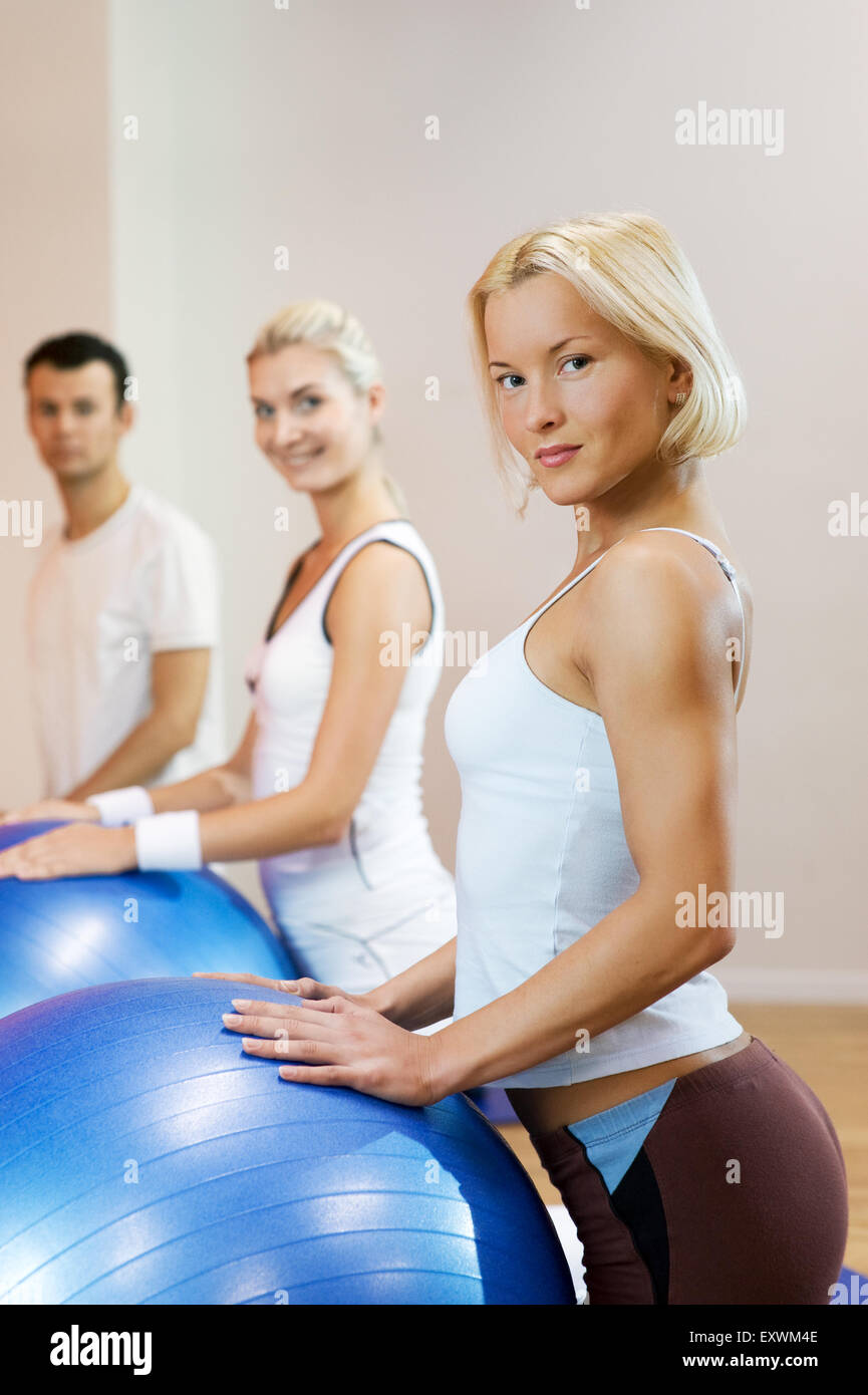Group of people doing fitness exercise with a ball Stock Photo - Alamy