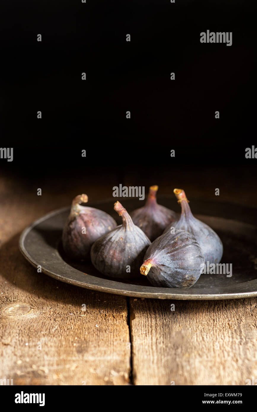 Fresh figs in moody natural lighting set with vintage style Stock Photo ...