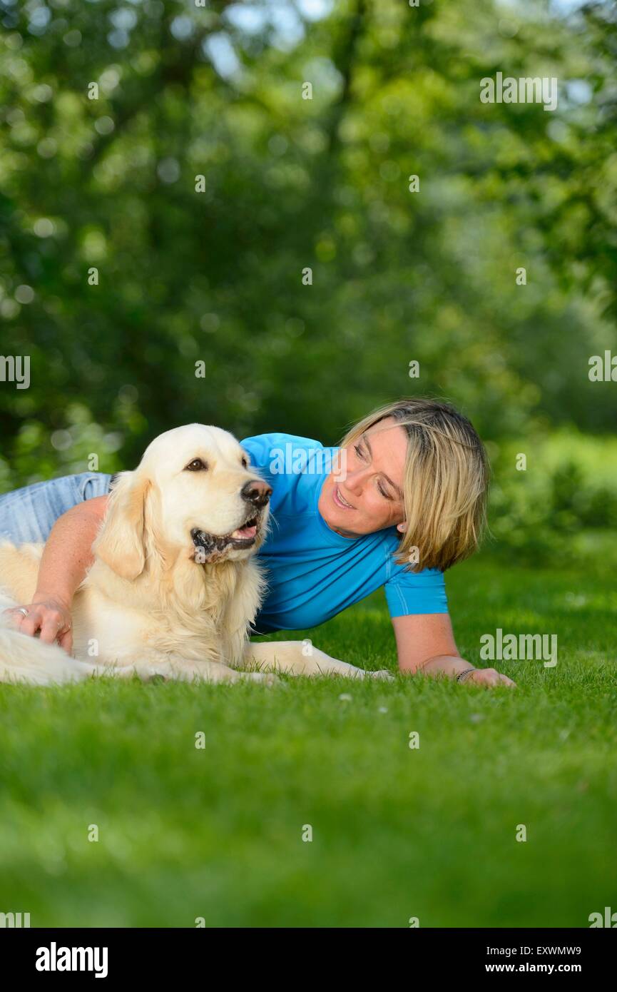 Mature woman lying on grass hi-res stock photography and images - Alamy