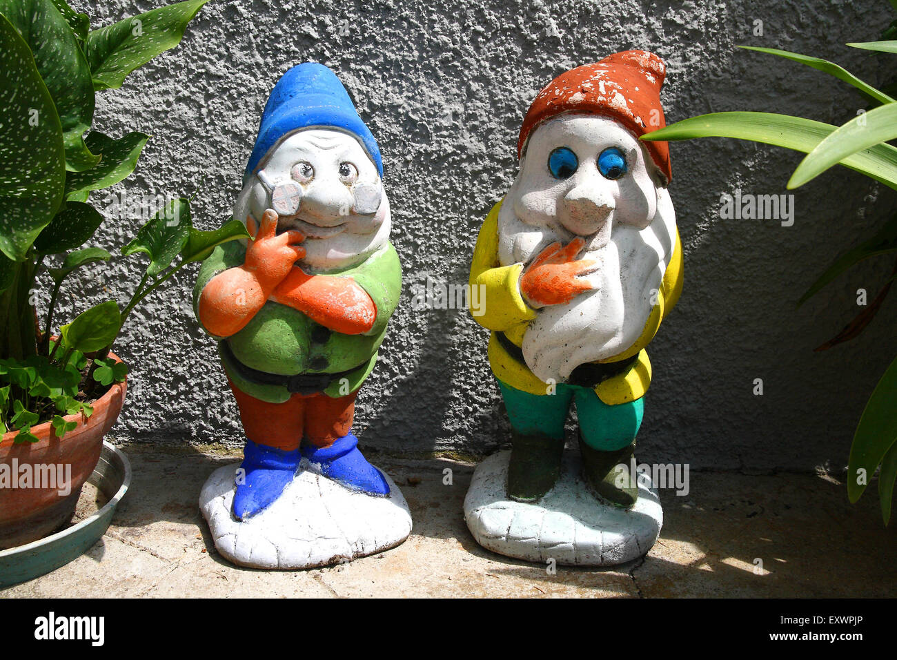 Two funny decorative dwarf in the garden Stock Photo - Alamy