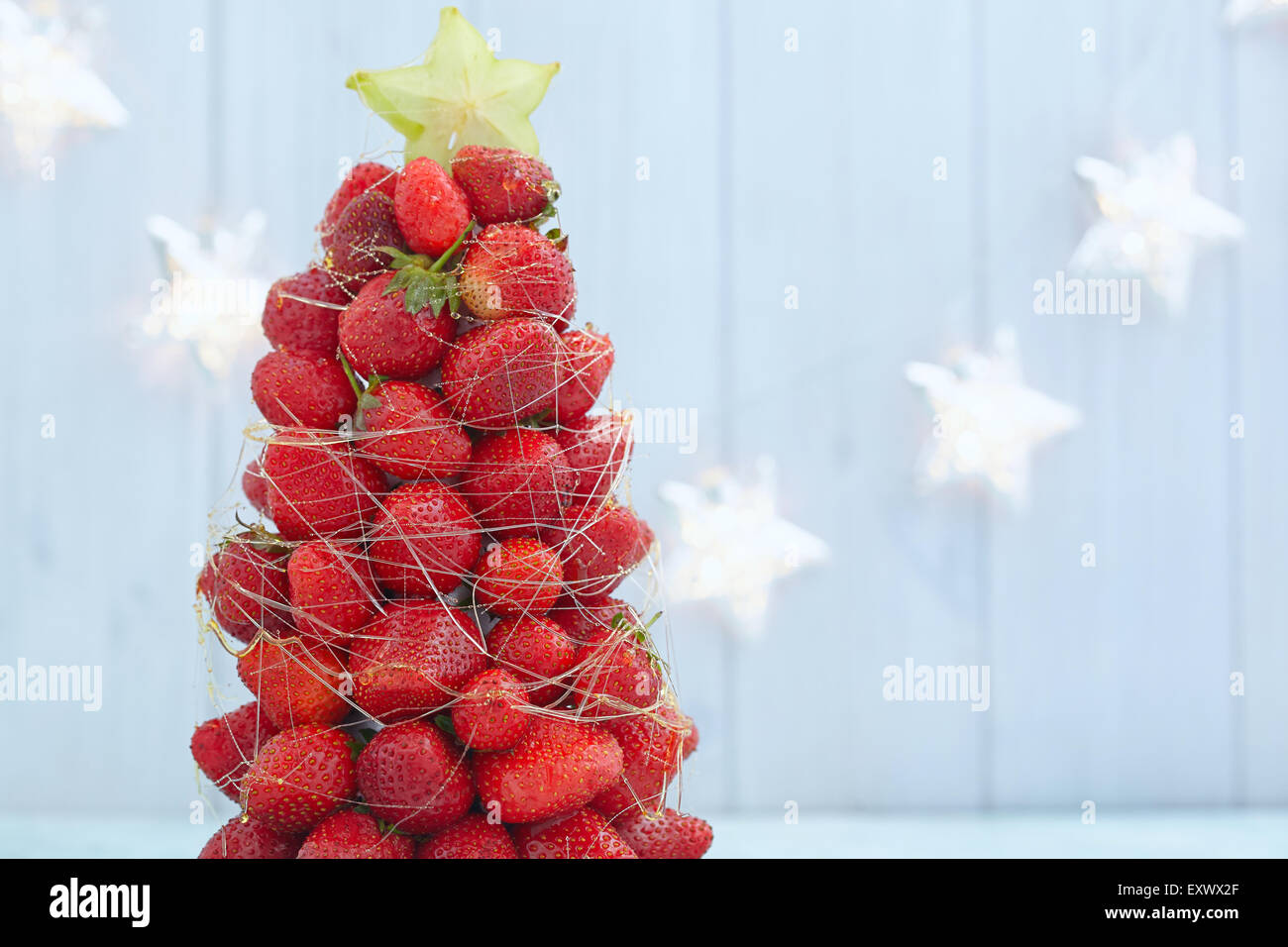 Strawberry Christmas tree with star fruit and caramel Stock Photo - Alamy