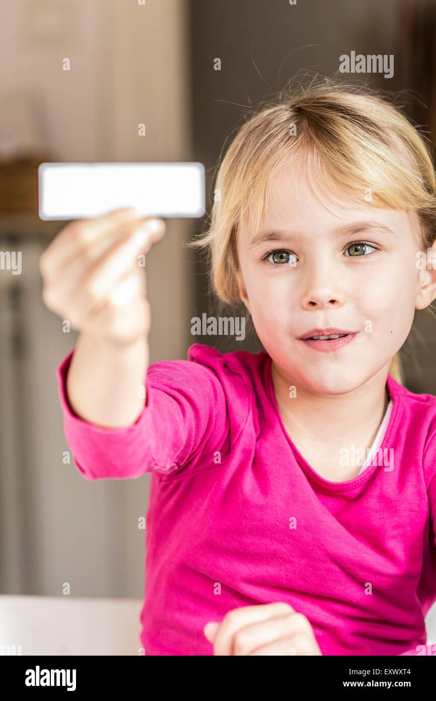 Blond girl holding aloft a white sign, Kiel, Schleswig-Holstein ...