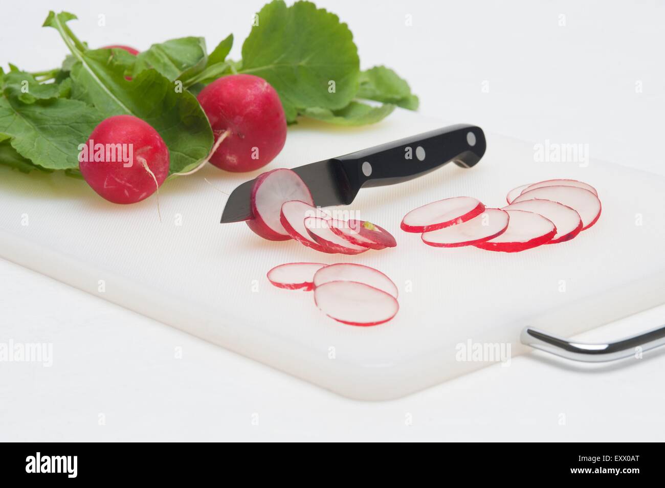 Chopping board with kitchen knife and radish Stock Photo - Alamy