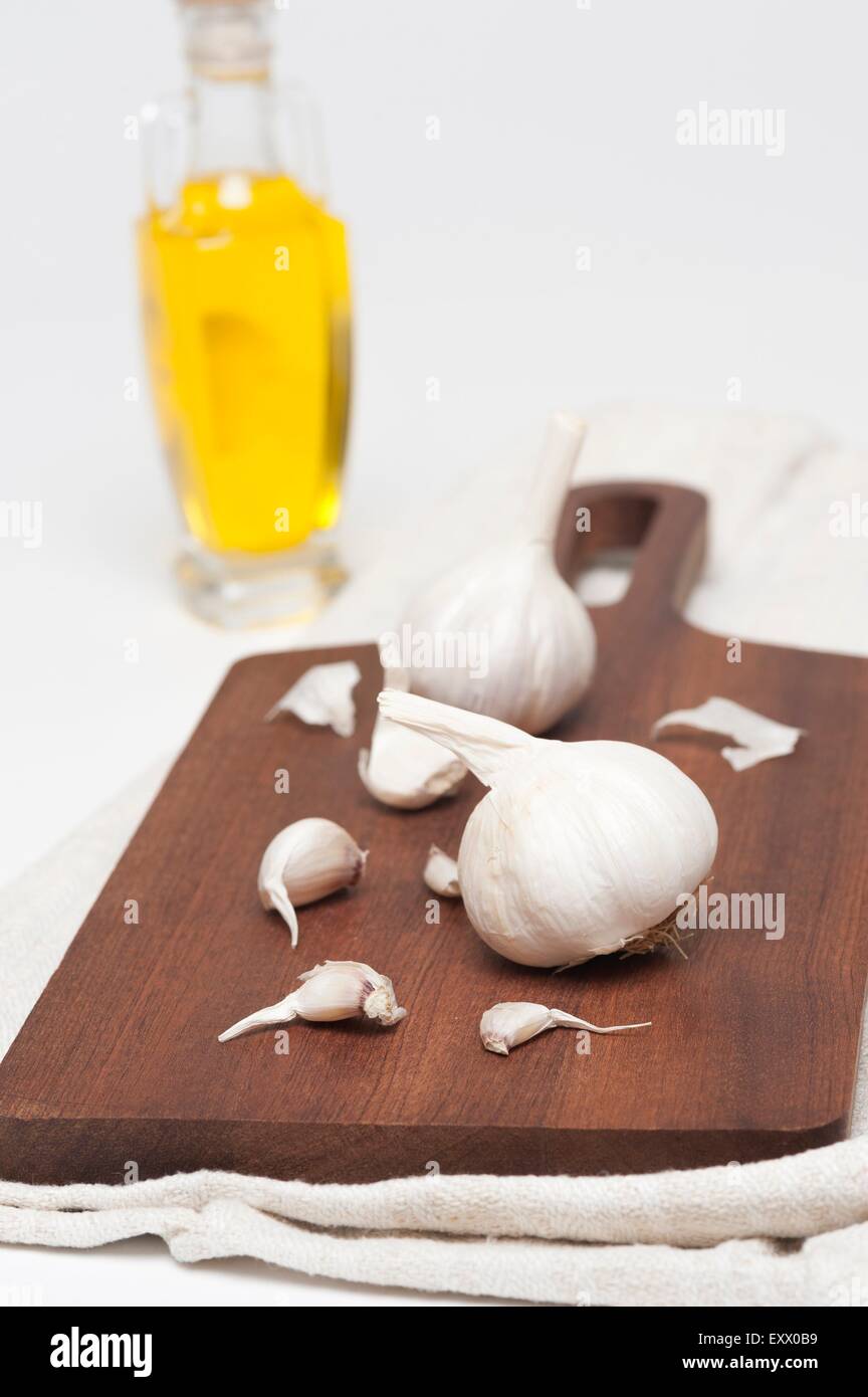 Oil bottle and garlic gloves on a slat Stock Photo - Alamy