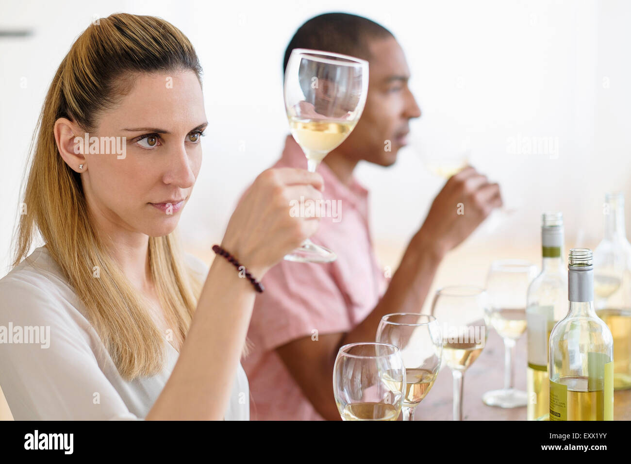 Man and woman tasting white wine Stock Photo - Alamy