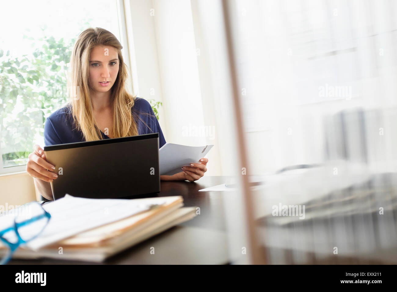 Woman writing in office hi-res stock photography and images - Alamy