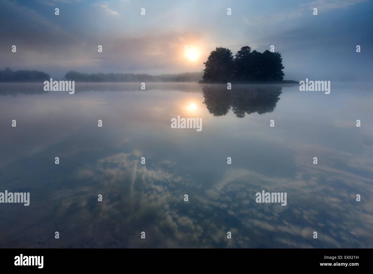 Beautiful sunrise over lake with reflections in water Stock Photo - Alamy