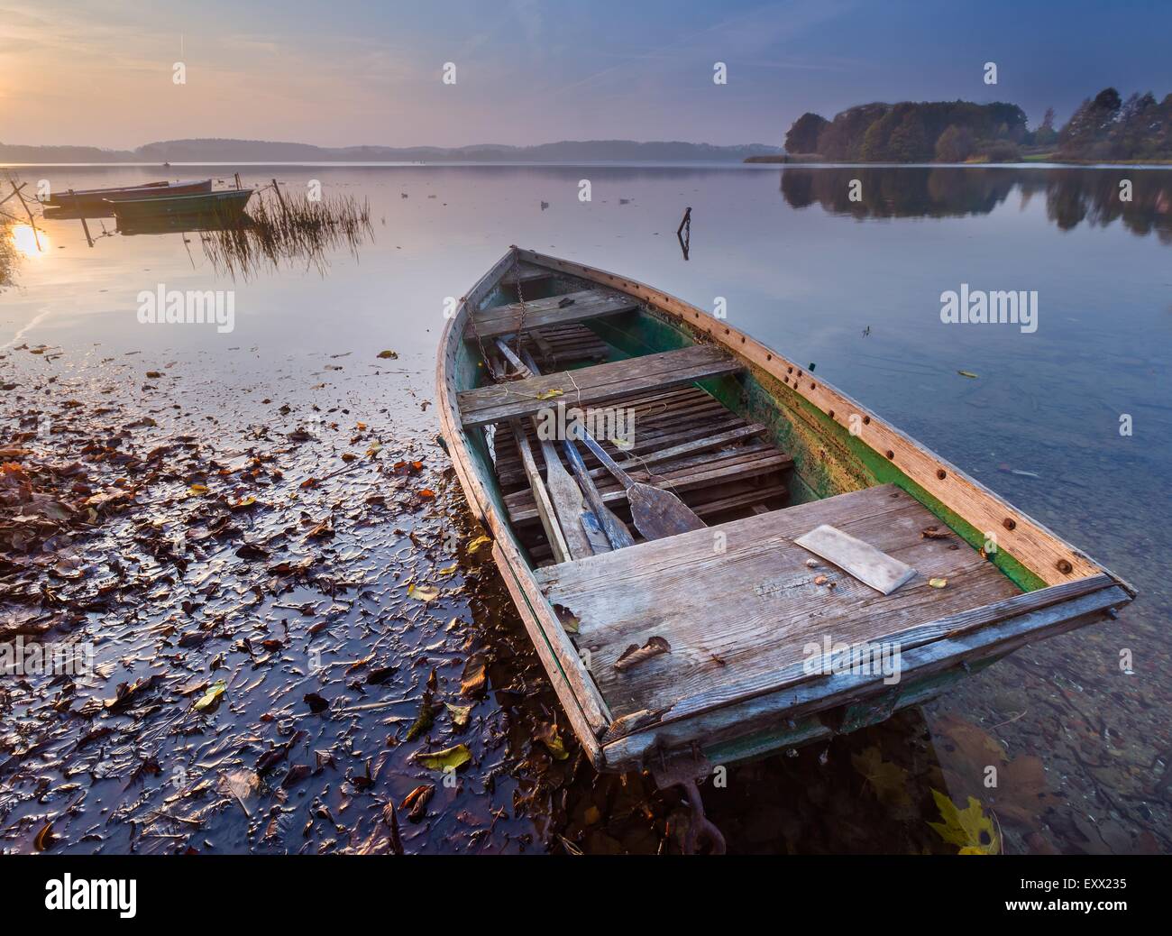 Beautiful lake landscape with fisherman boat and sunset sky. Typical ...