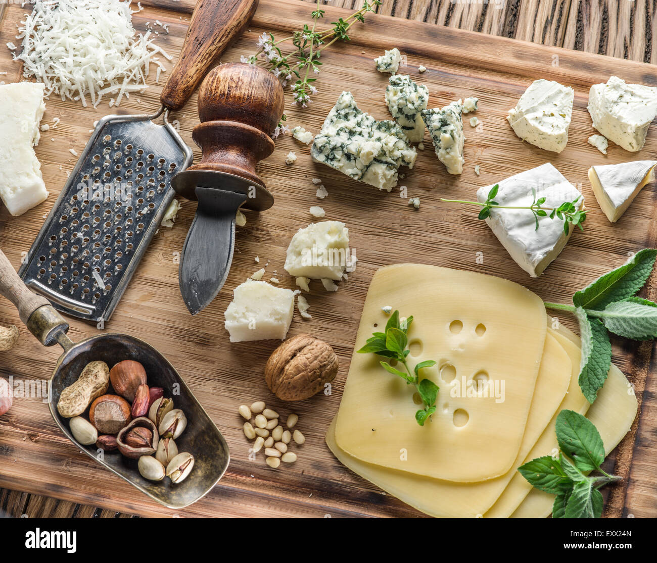 Different types of cheeses with nuts and herbs. Top view Stock Photo ...