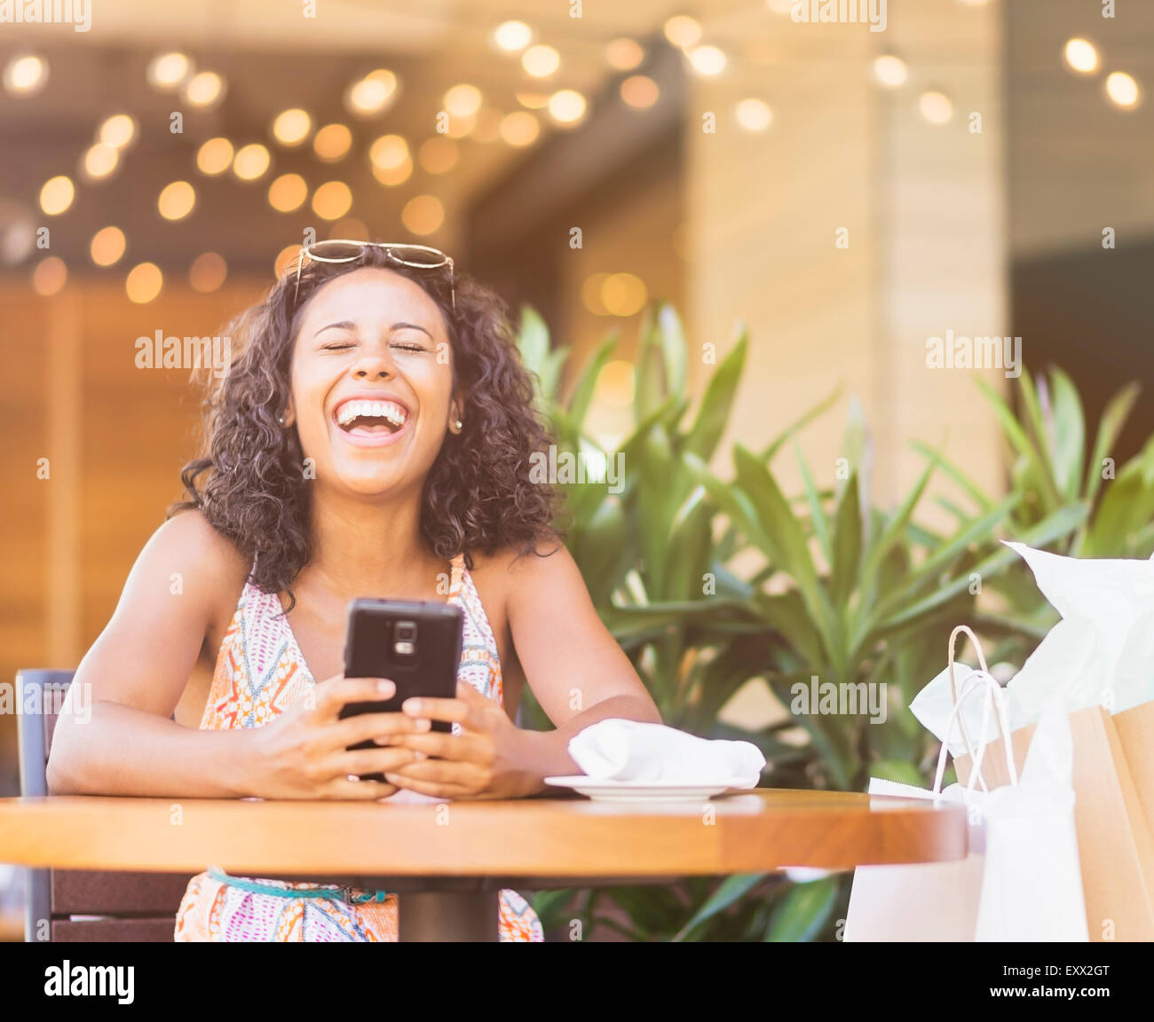 Woman using phone in cafe Stock Photo - Alamy