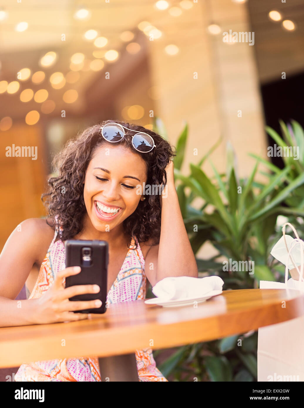 Woman using phone in cafe Stock Photo - Alamy