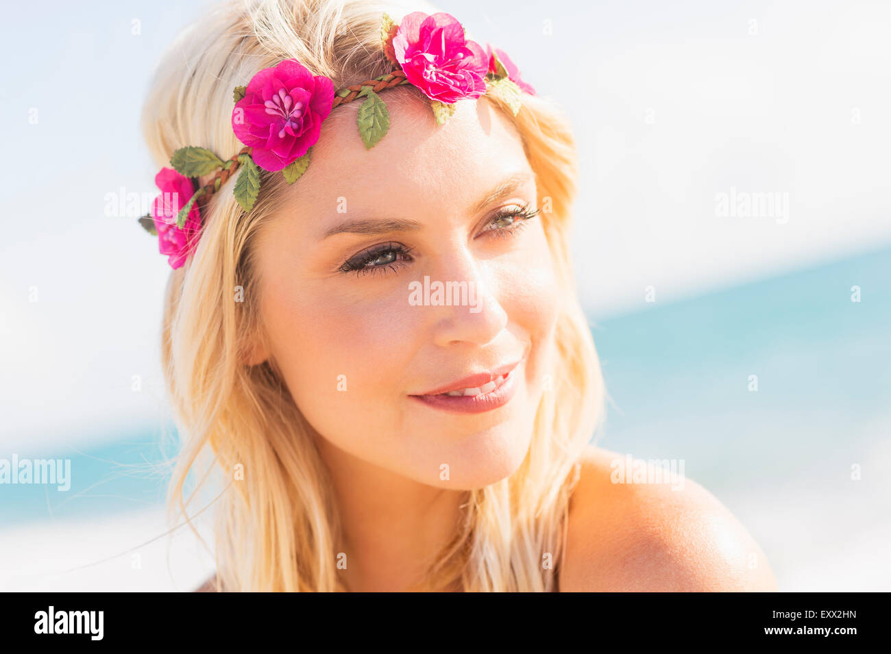 Young woman smiling on beach Stock Photo - Alamy
