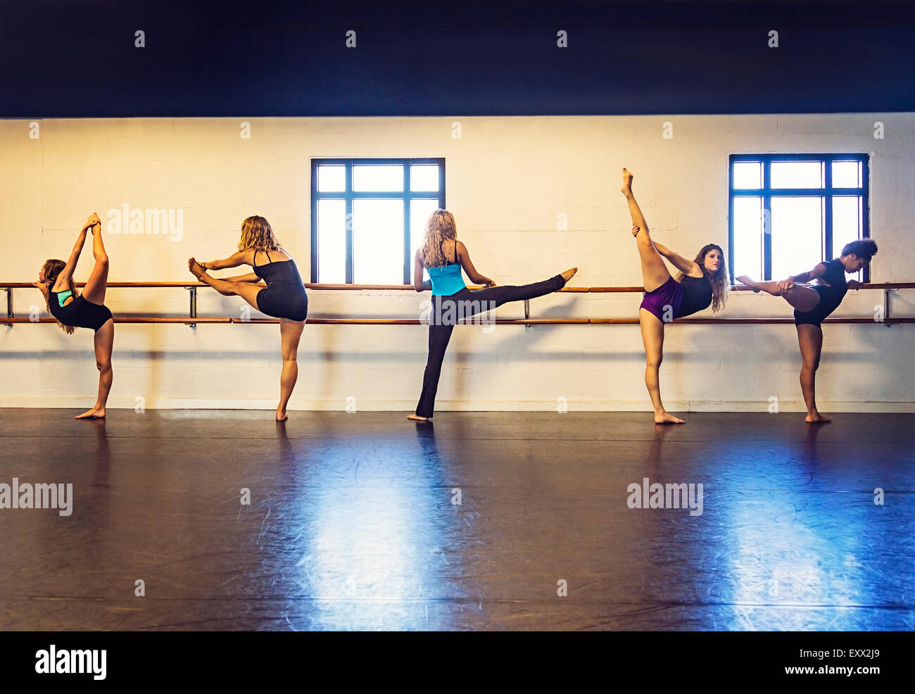 Dancers stretching in dance studio Stock Photo - Alamy