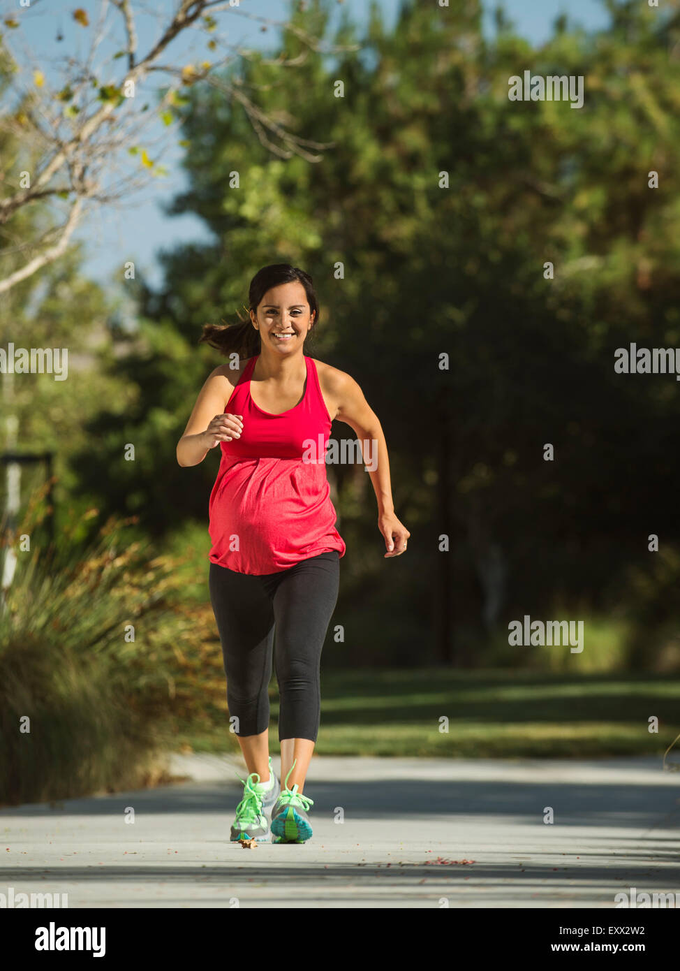 Pregnant woman running outdoors Stock Photo - Alamy