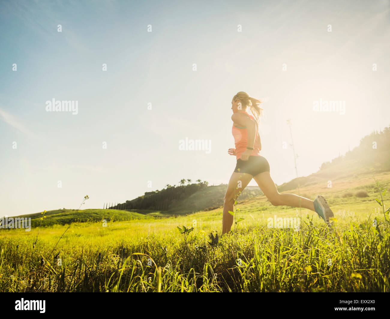 Woman running in field Stock Photo - Alamy