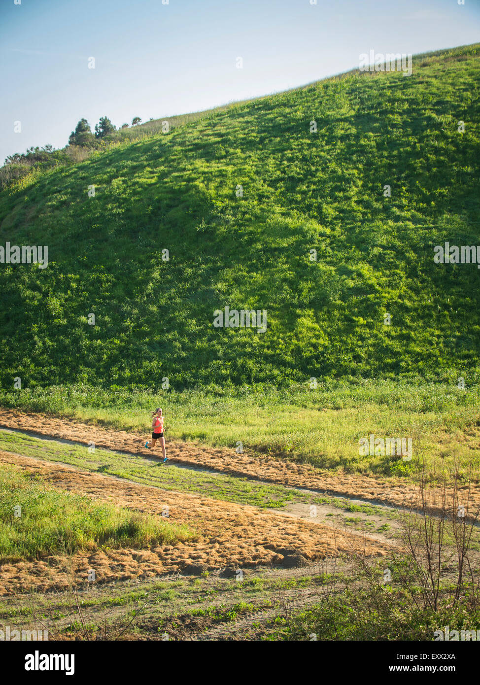 Woman running in field Stock Photo - Alamy