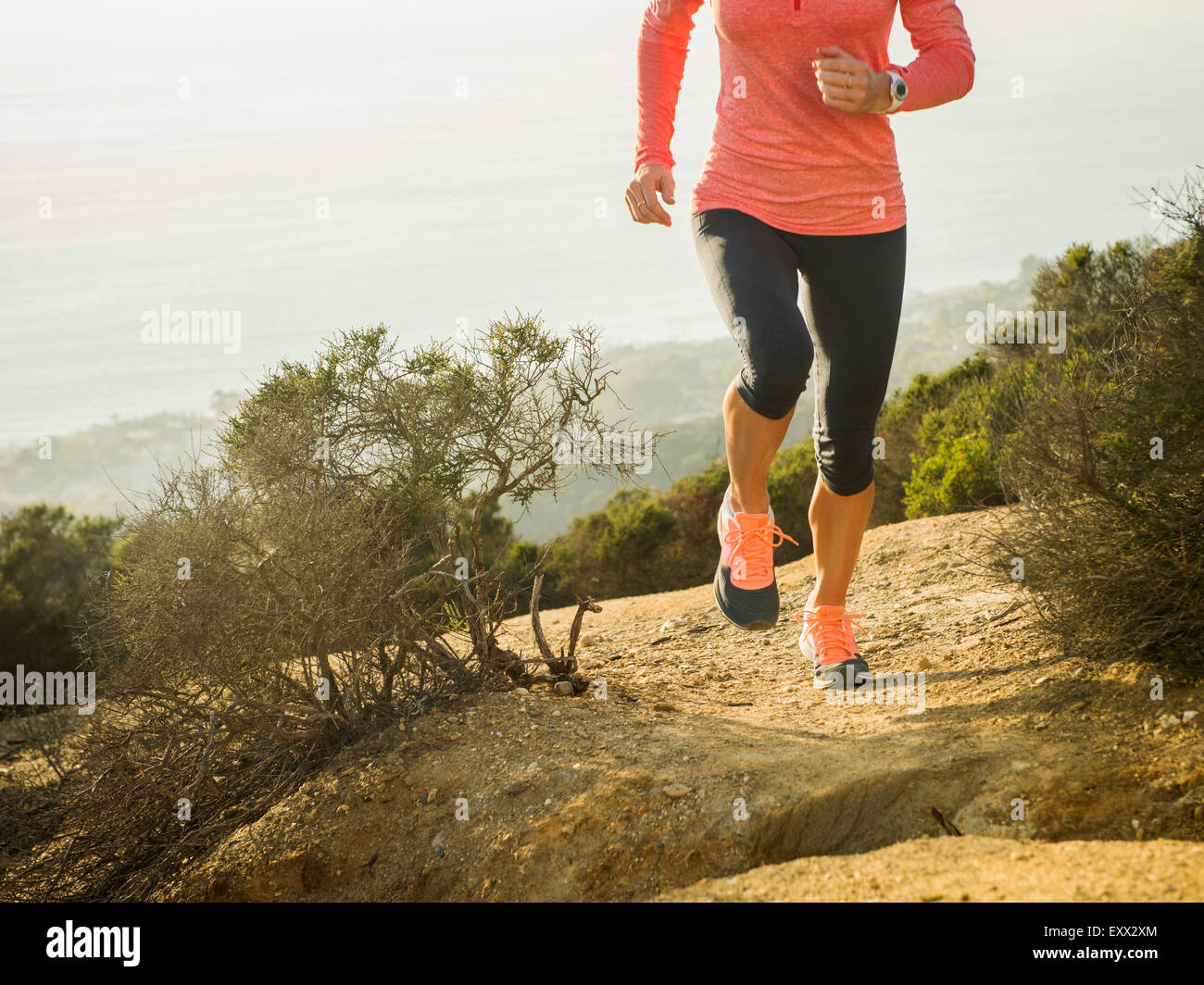 Woman running in mountains Stock Photo - Alamy