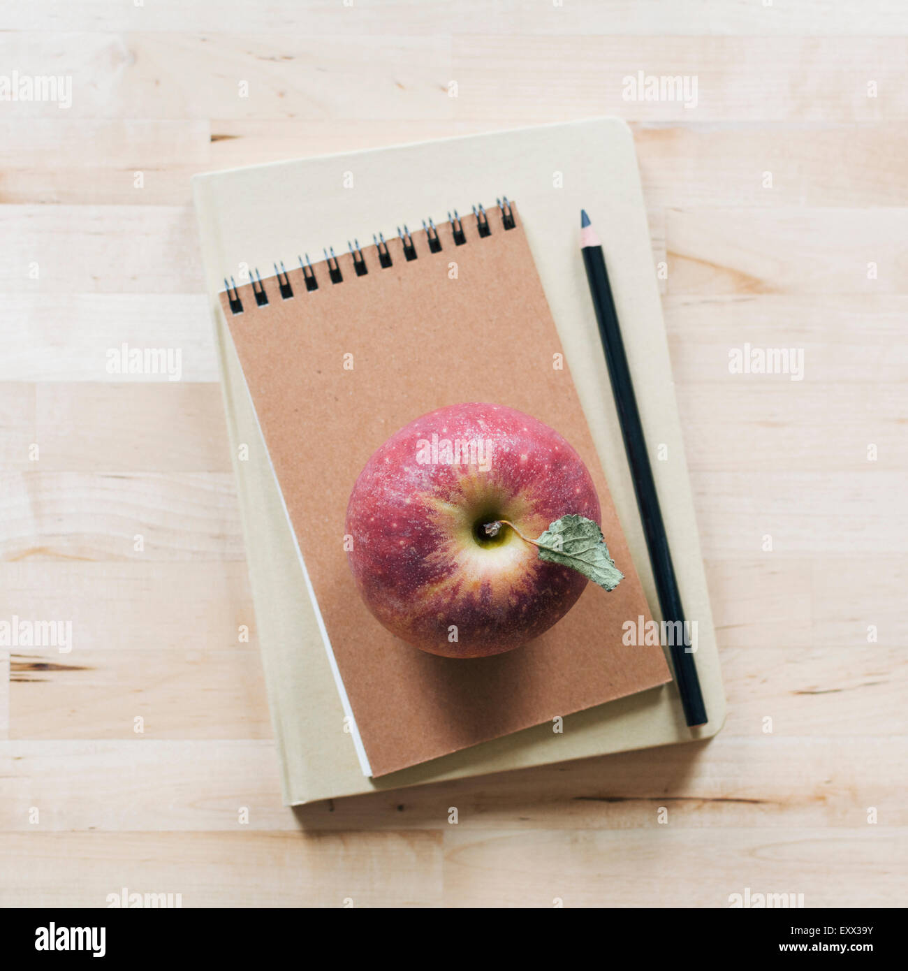Apple on notebook Stock Photo - Alamy
