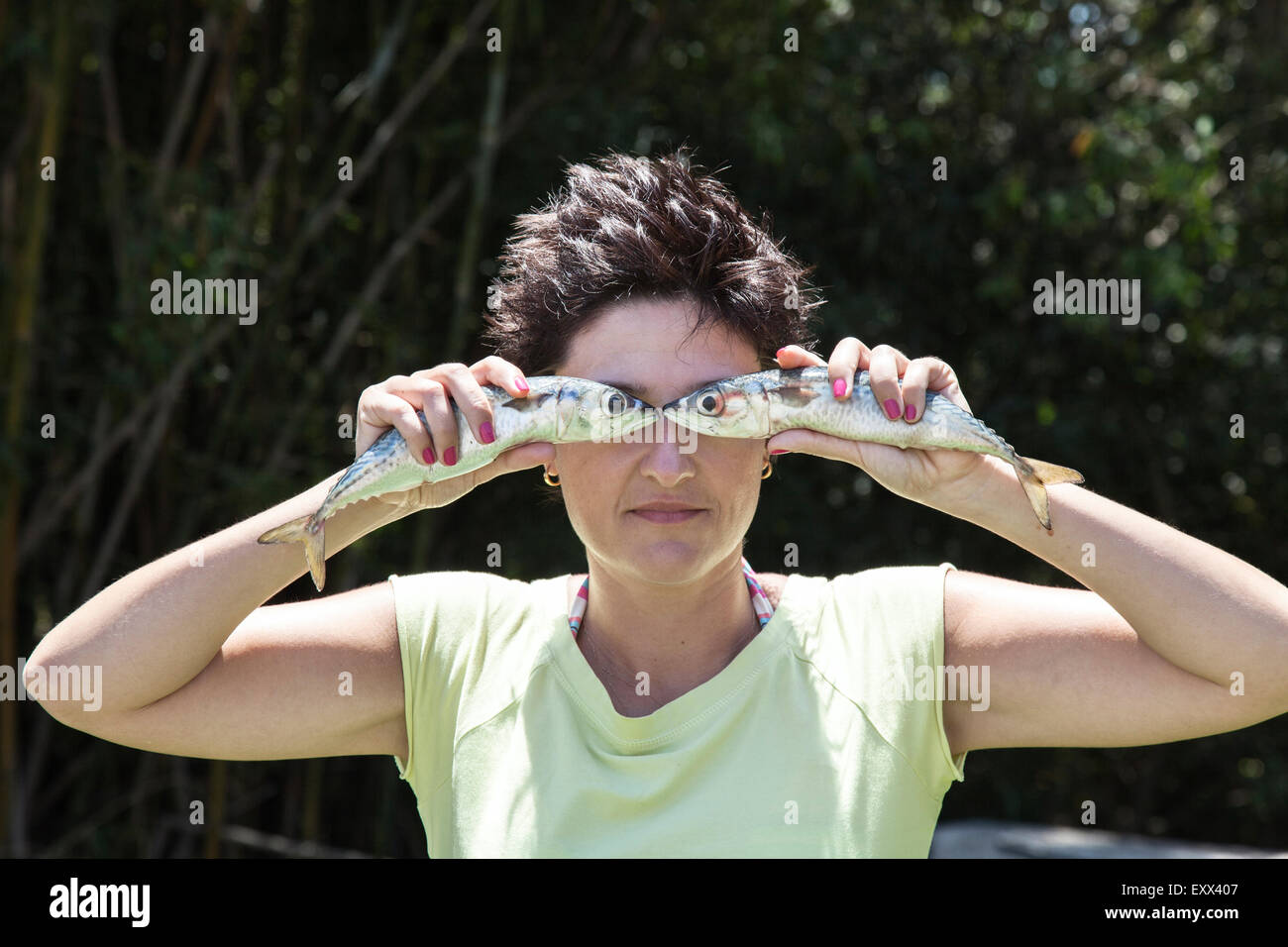 Woman with two fish in the eyes Stock Photo - Alamy