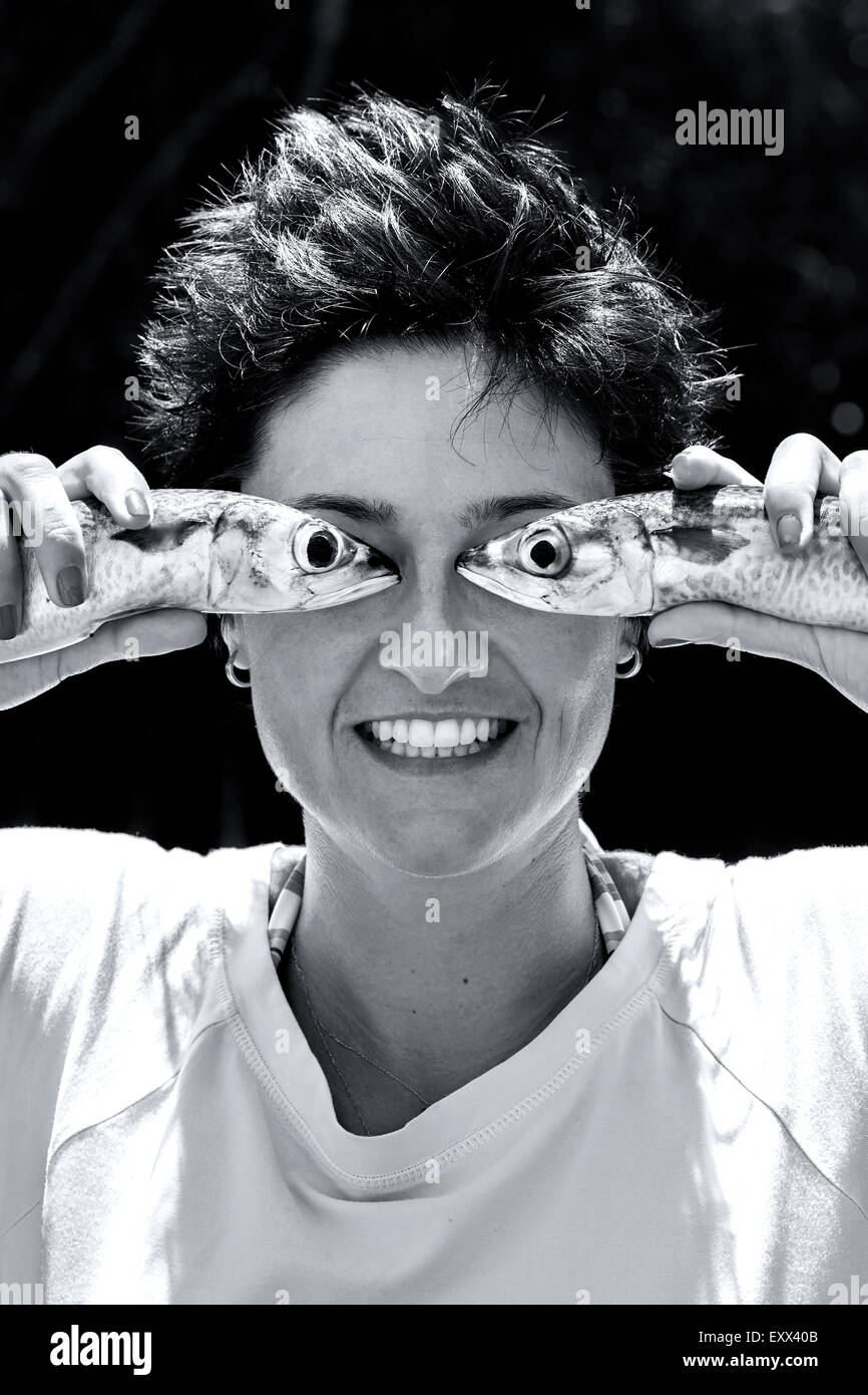 Woman with two fish in the eyes Stock Photo - Alamy