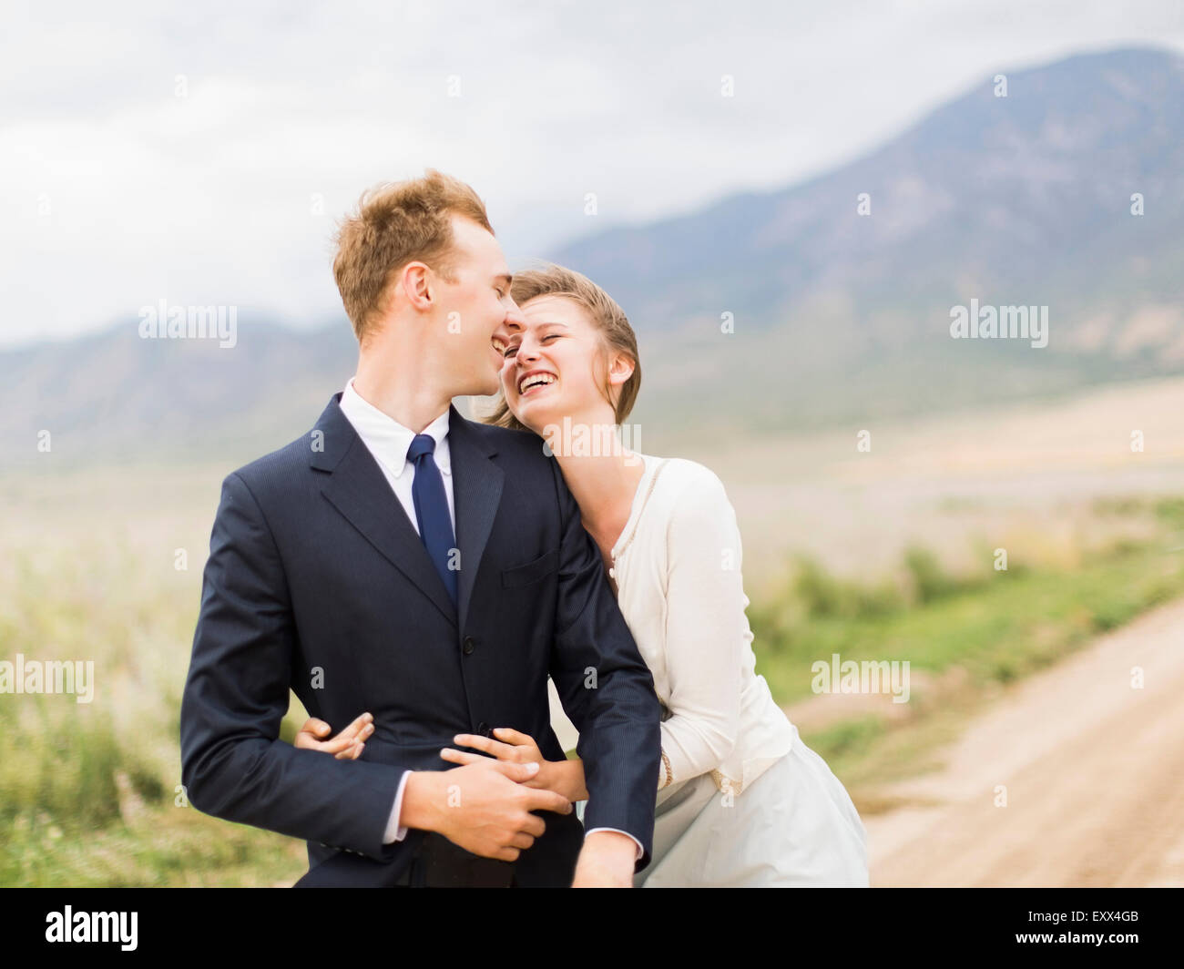 Happy wedding couple smiles hugs hi-res stock photography and images ...