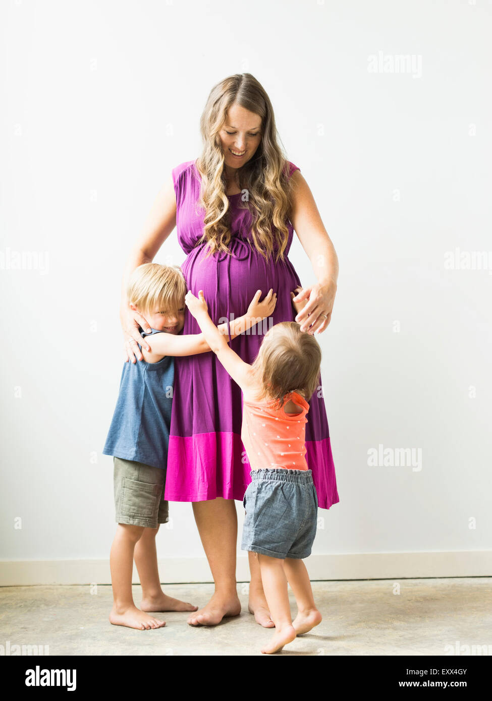 Pregnant mother hugging children hi-res stock photography and images - Alamy