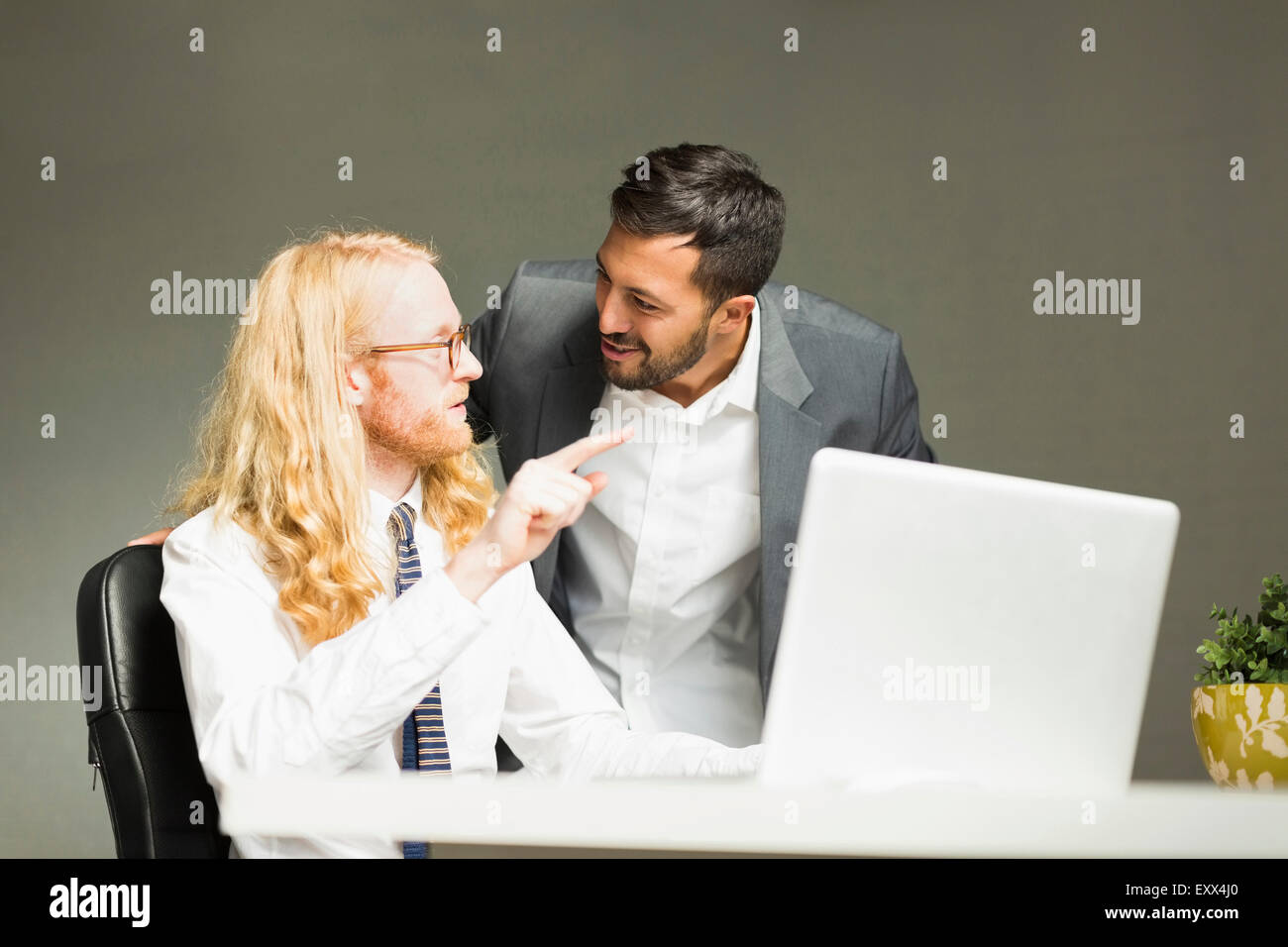 Businessmen talking in office Stock Photo - Alamy