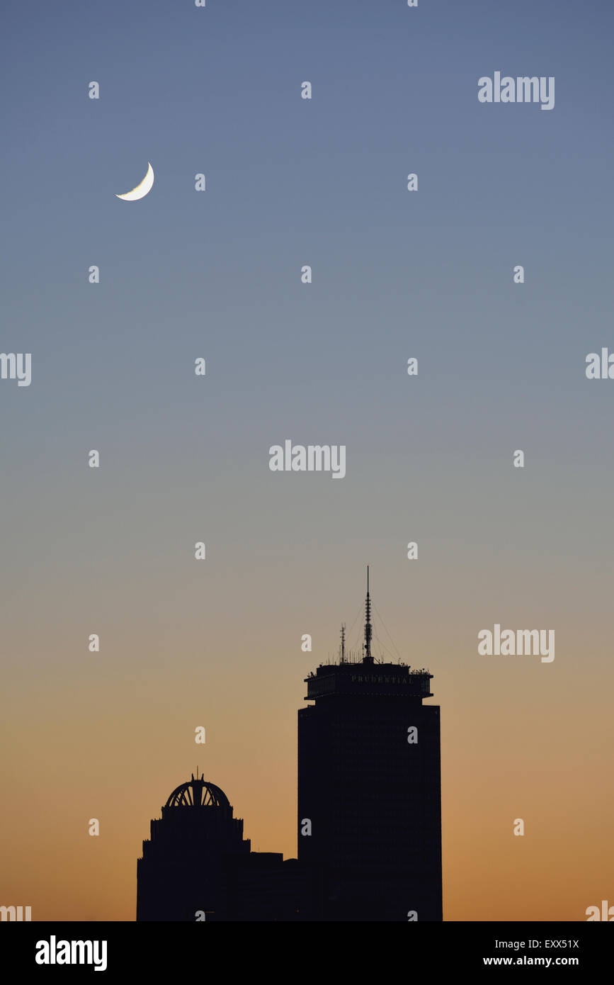 Crescent moon above office buildings Stock Photo - Alamy