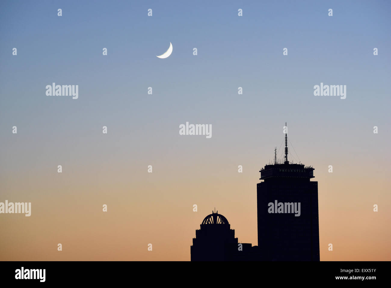 Crescent moon above office buildings Stock Photo - Alamy
